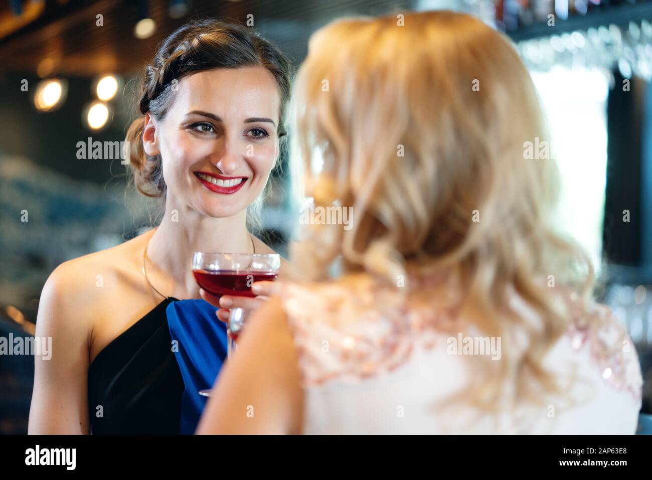 Women drinking alcohol in a bar Stock Photo - Alamy