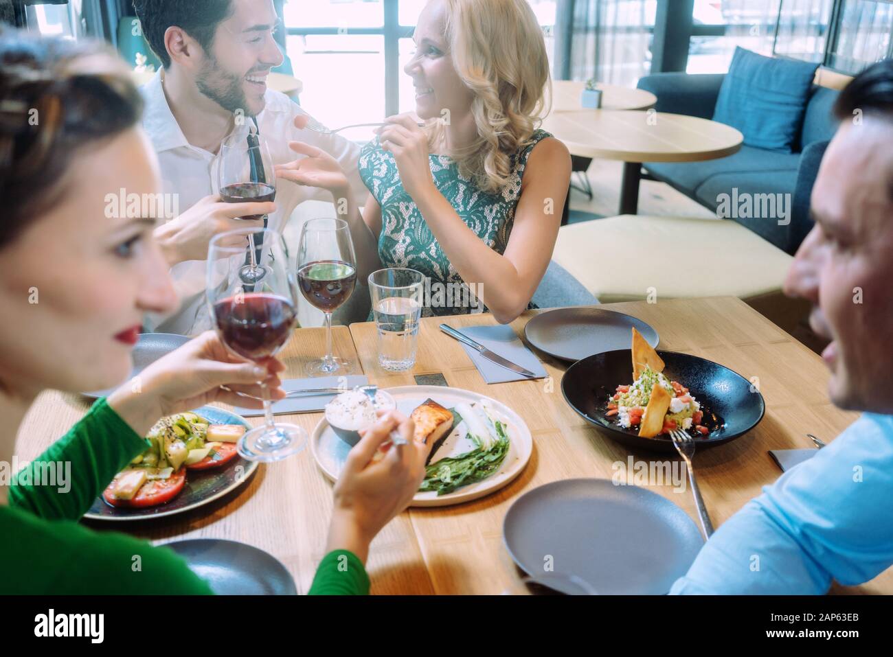 Friends in a restaurant having a jolly good time enjoying the food ...
