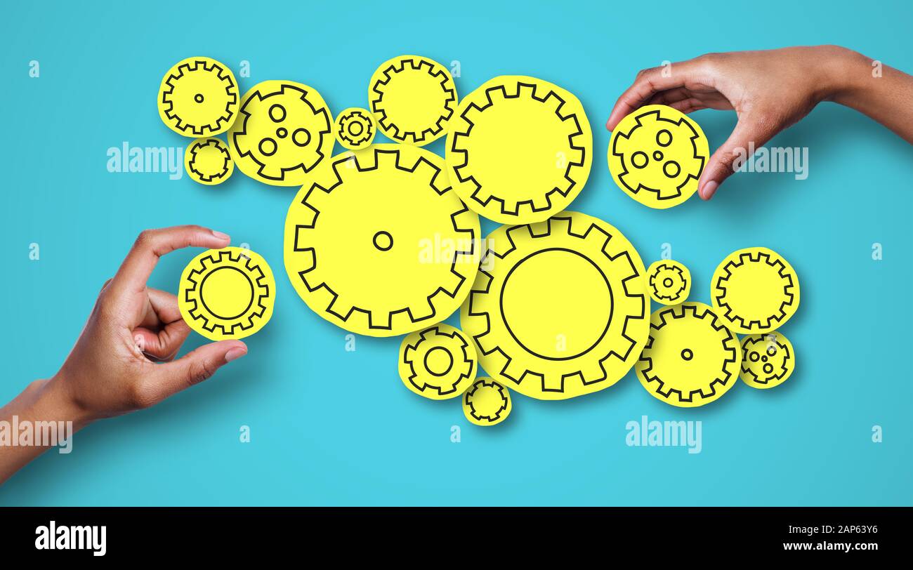 Two hands adding gears to shining mechanism over blue background Stock ...