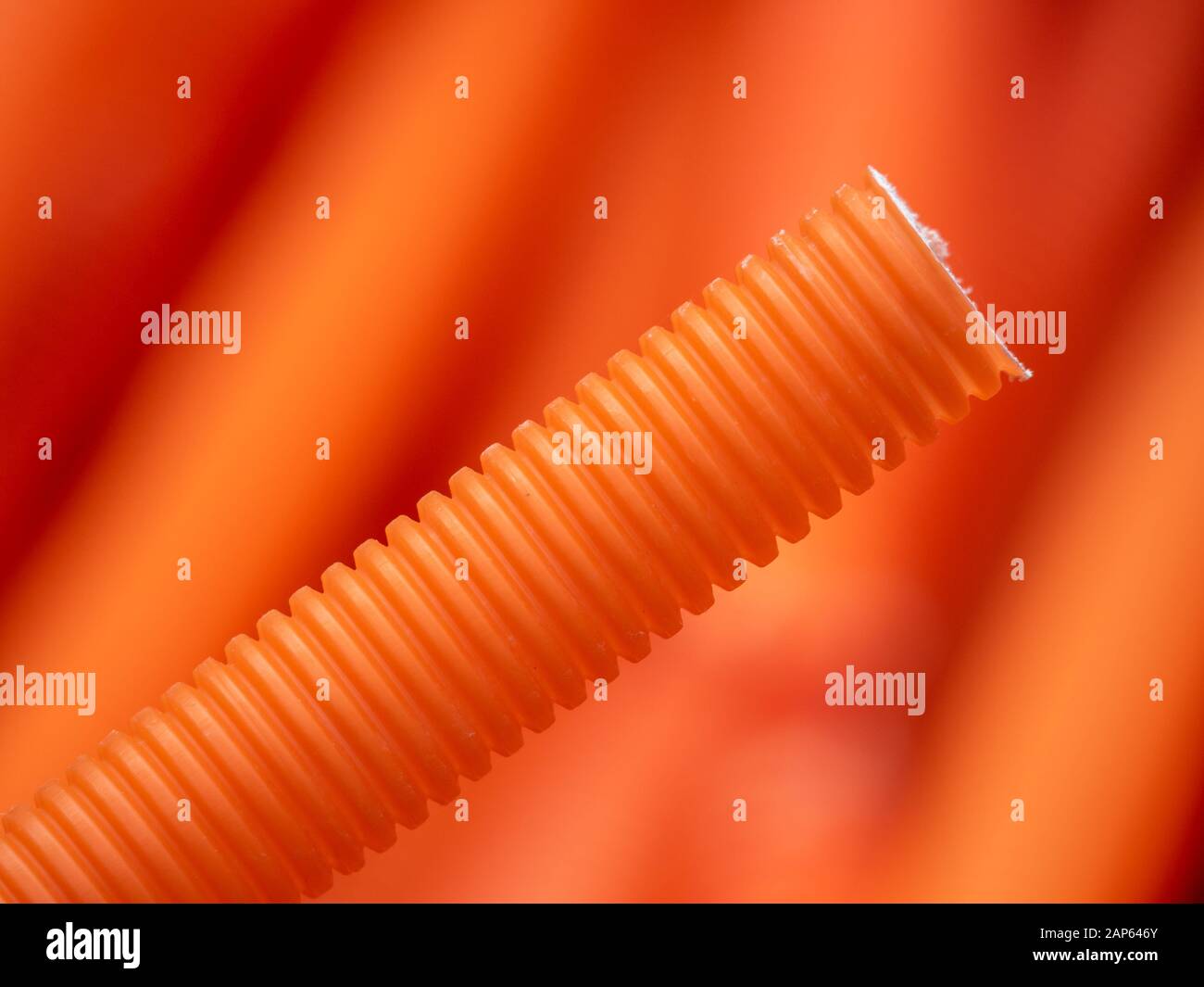 Orange electric insulation pipe Stock Photo - Alamy