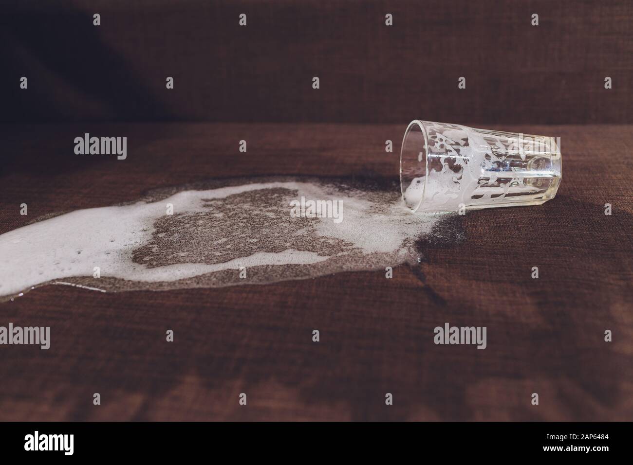 Alcoholism in the family. Beer bottle and spilled beer in the sofa ...