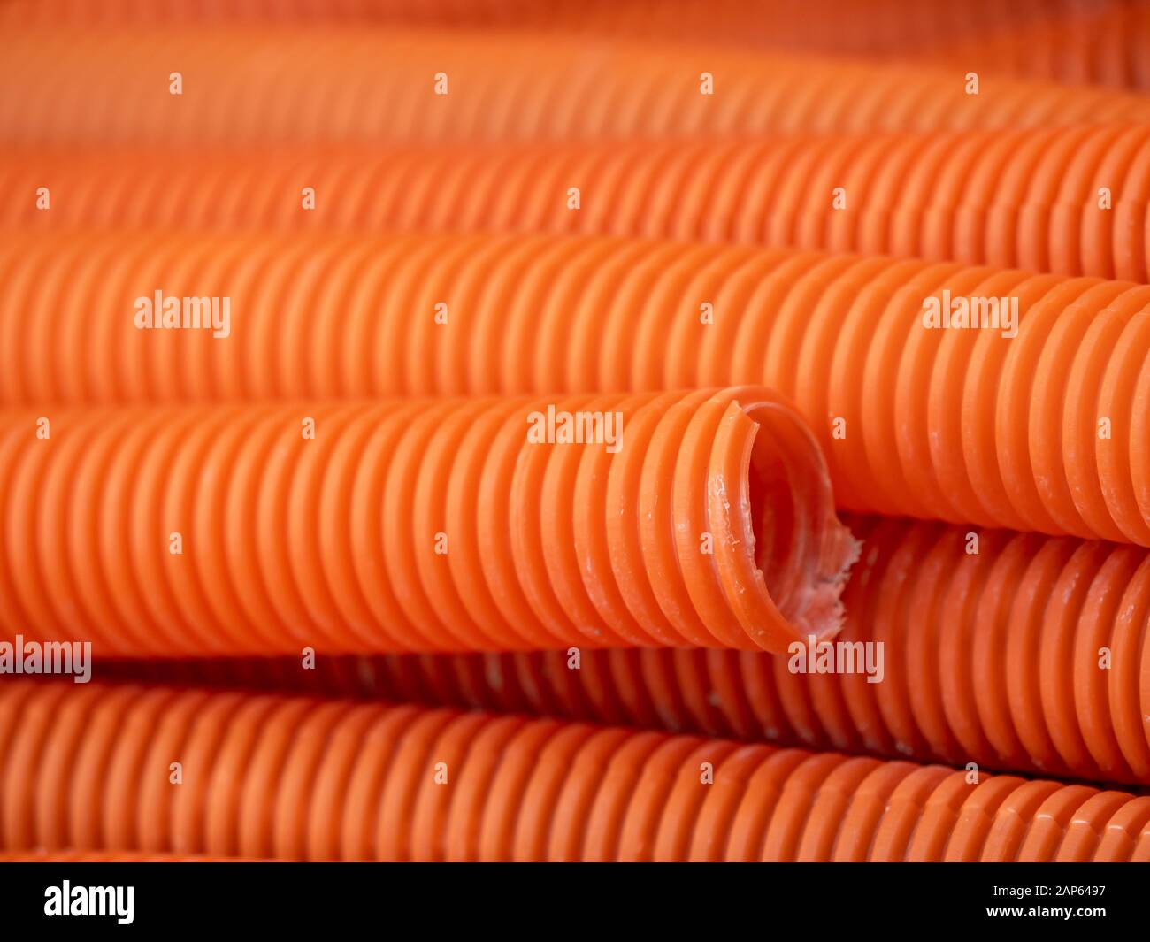 Orange electric insulation pipe Stock Photo - Alamy
