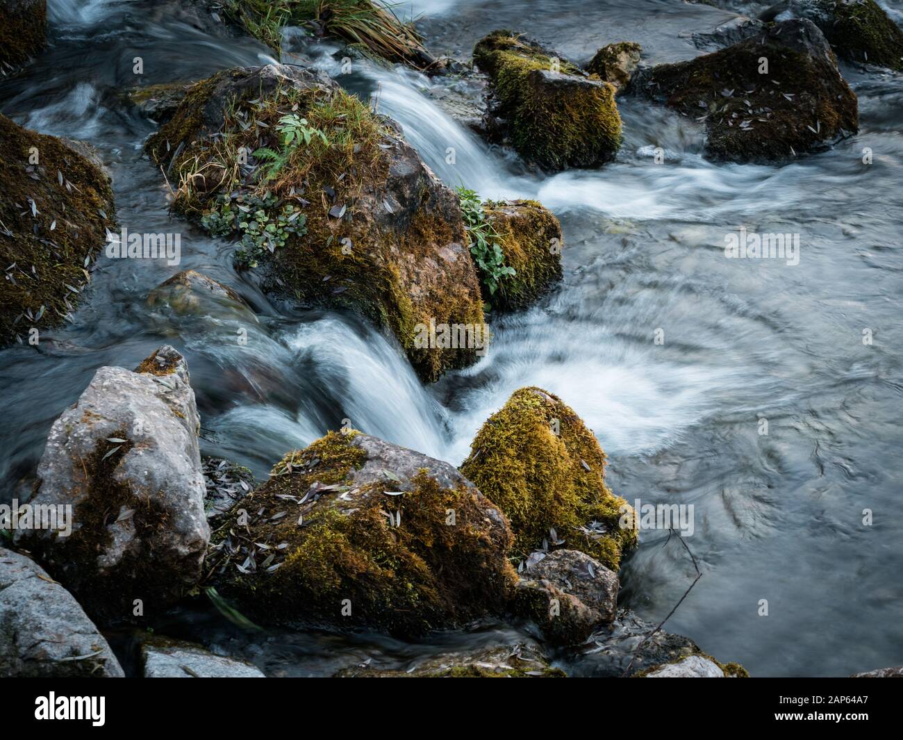 Long exposure waterfall over rocks in forest landscape Stock Photo - Alamy
