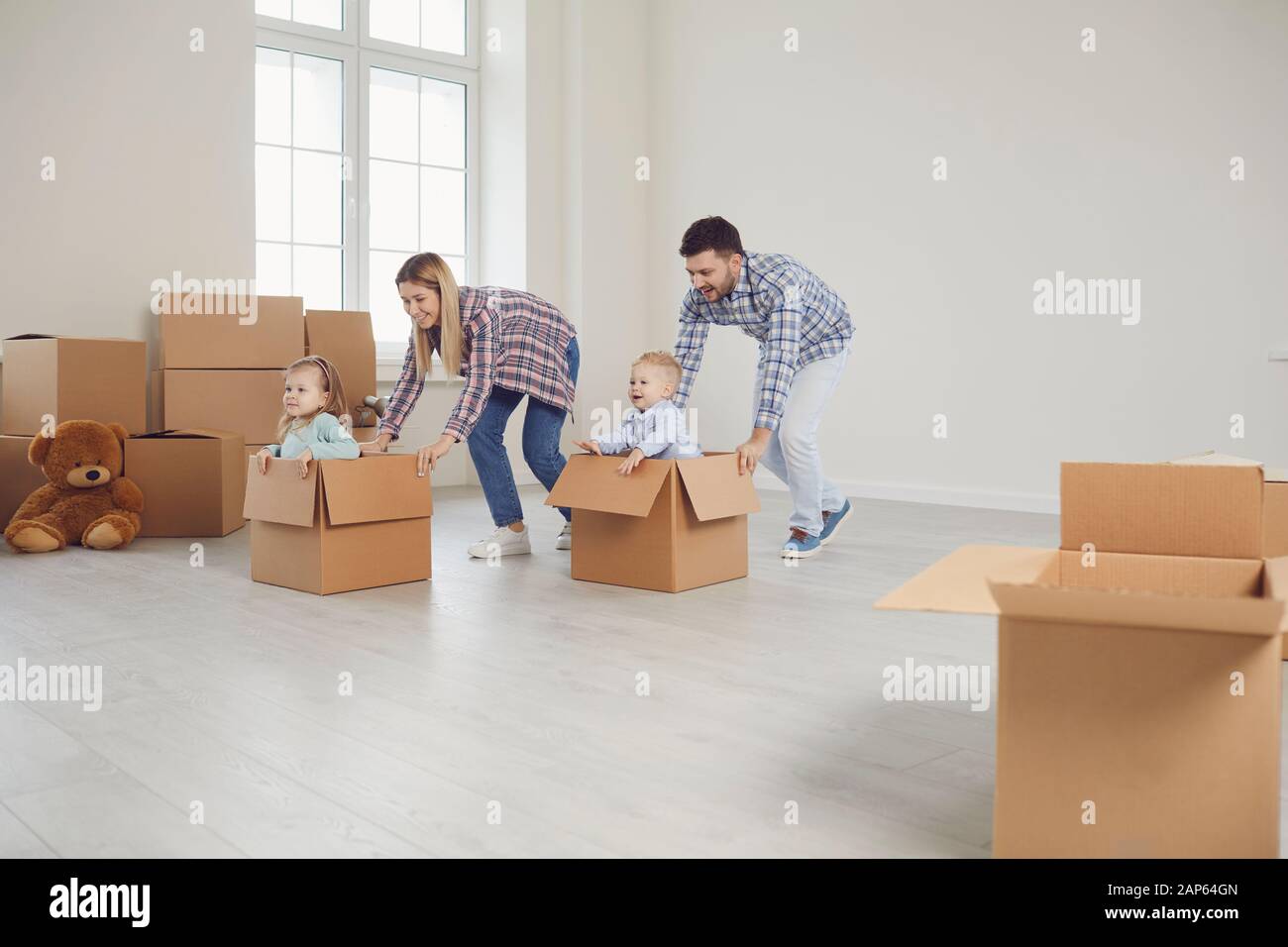Happy family have fun playing in a new house in the room Stock Photo ...