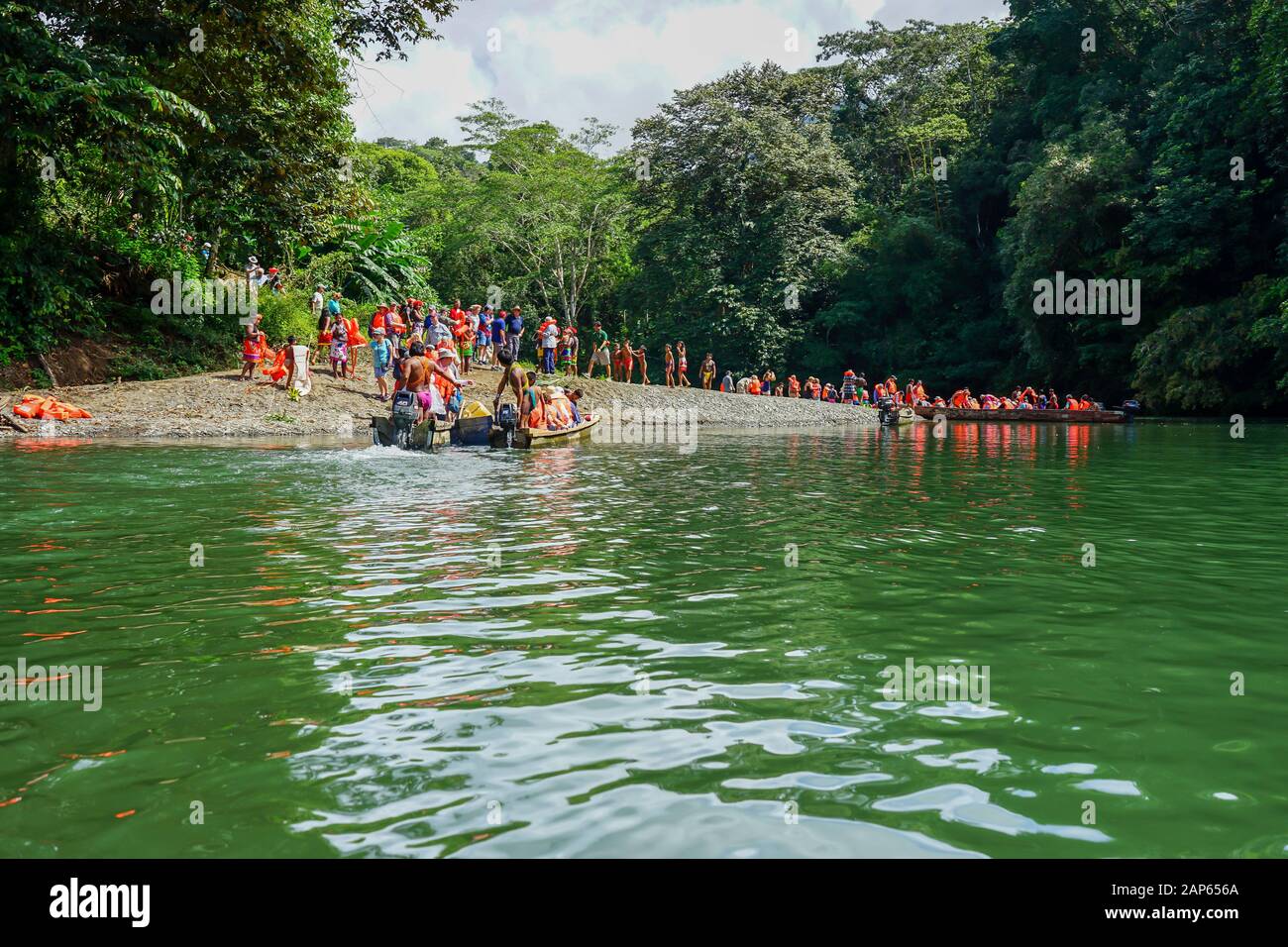 Tourist in dugout canoe arriving at the Village, Embera Puru Village in ...
