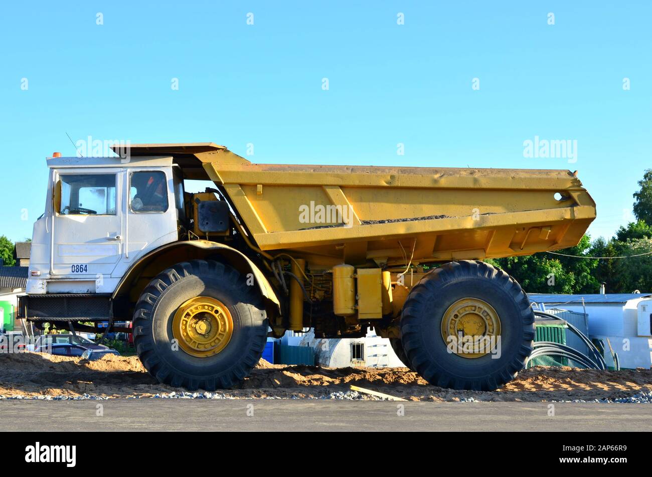 Big yellow dump truck working on the construction site - Image Stock ...