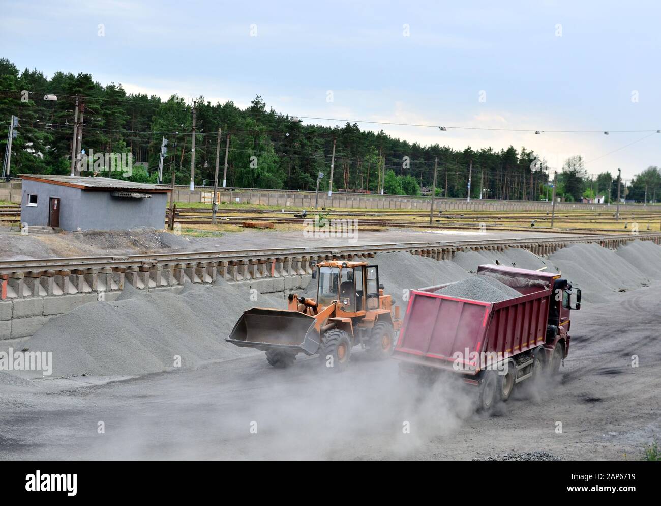 Wheel loader unload gravel and crushed stone in the dump truck ...