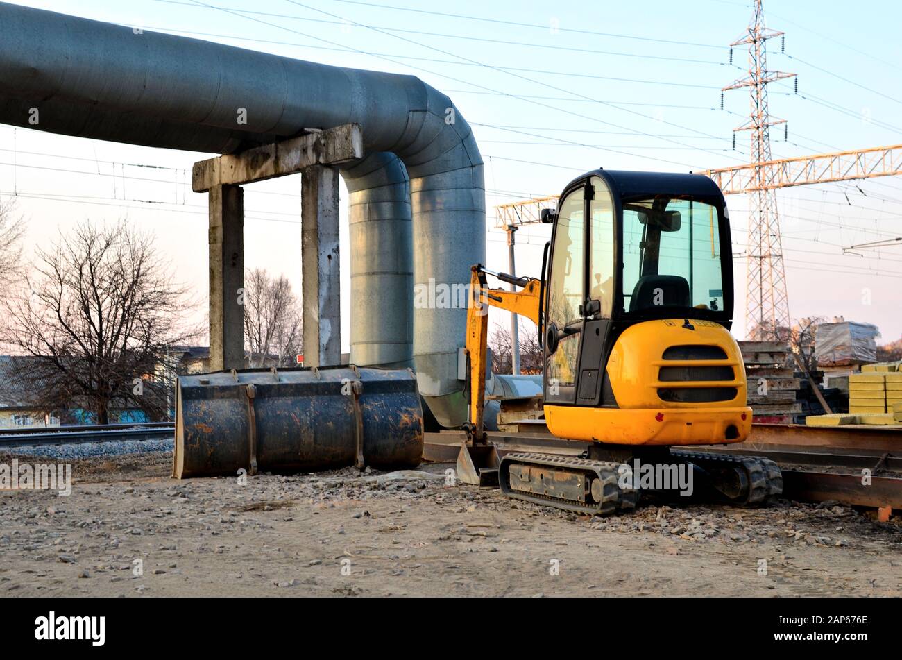 Mini excavator on a construction site, on a street reconstruction Stock ...