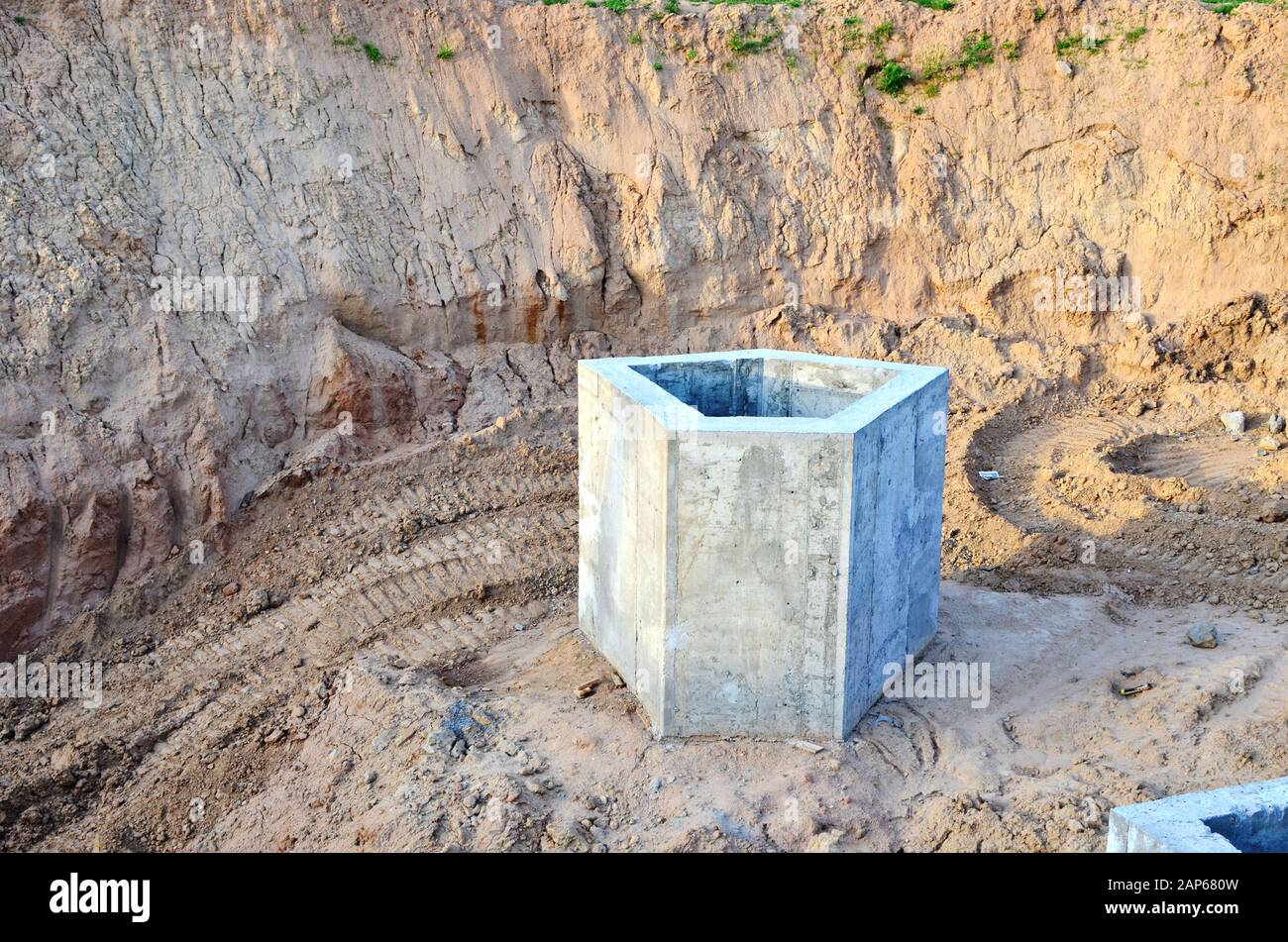 Installation of concrete sewer wells in the ground at the construction ...