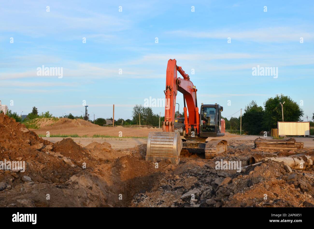 Crawler excavator in construction site on the background of tower ...