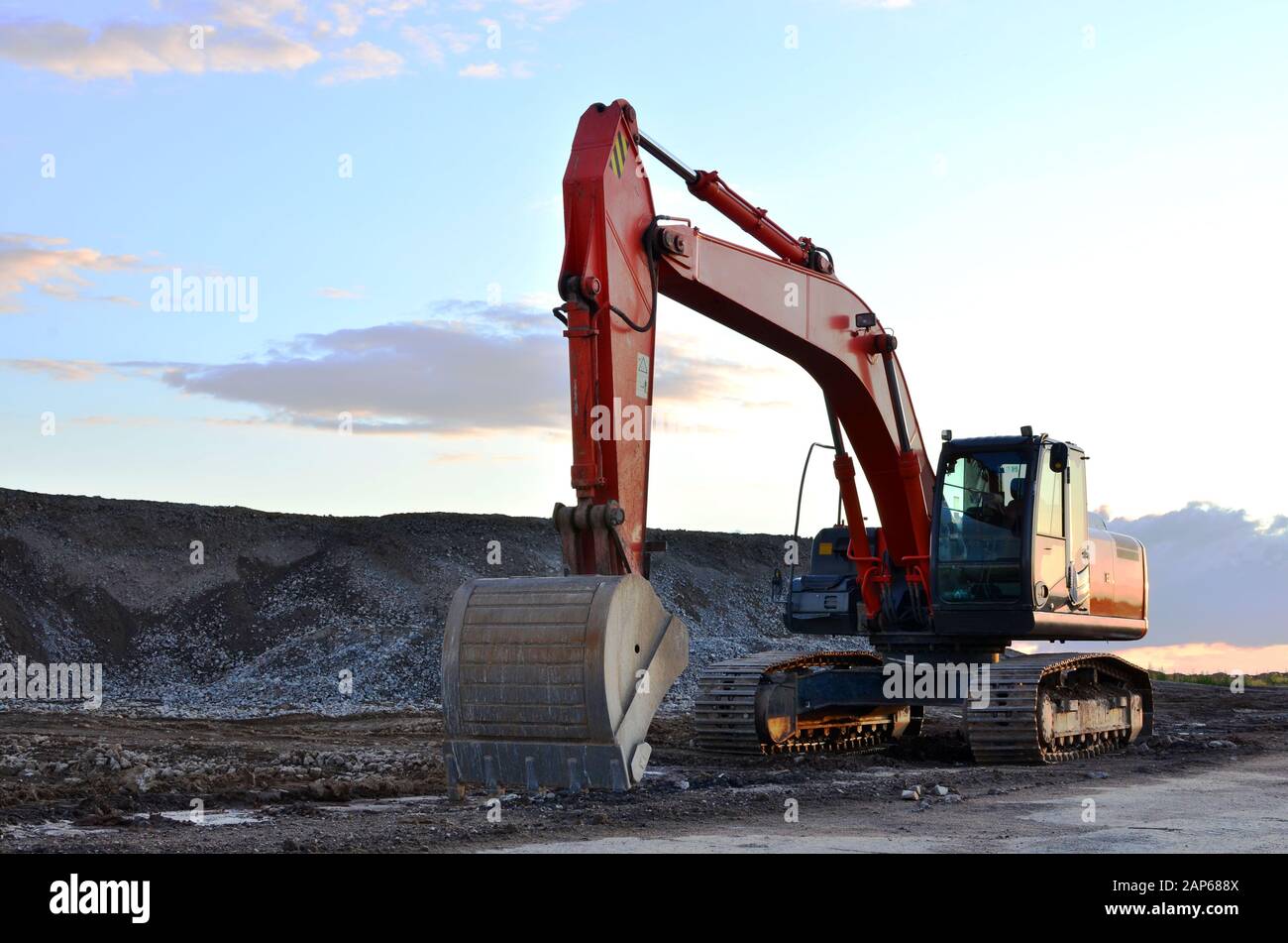 Large tracked excavator works in a gravel pit. Loading of stone and ...