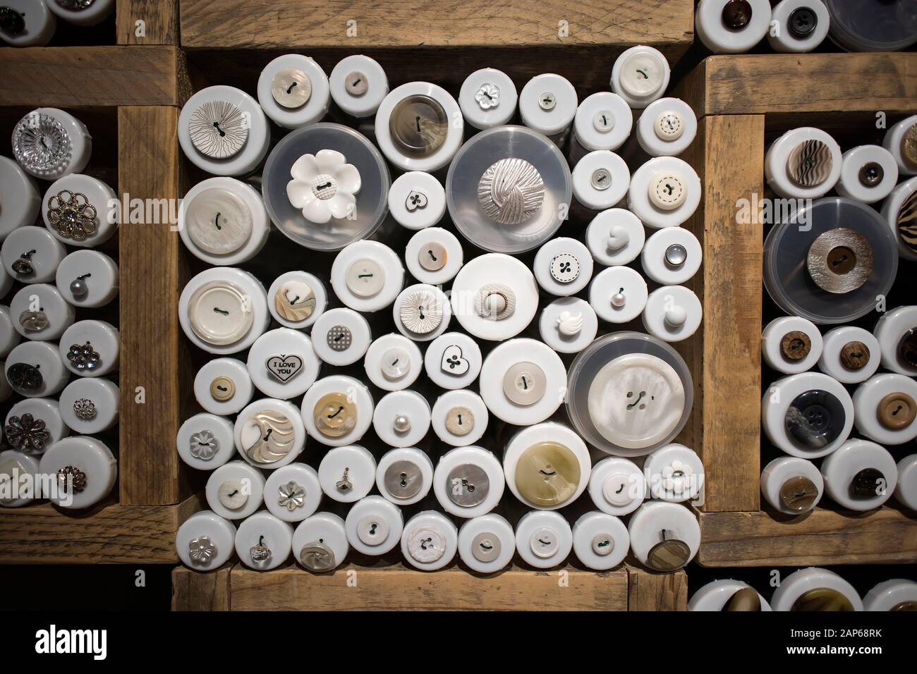 Multi-colored buttons in wooden boxes for sale in a store Stock Photo ...