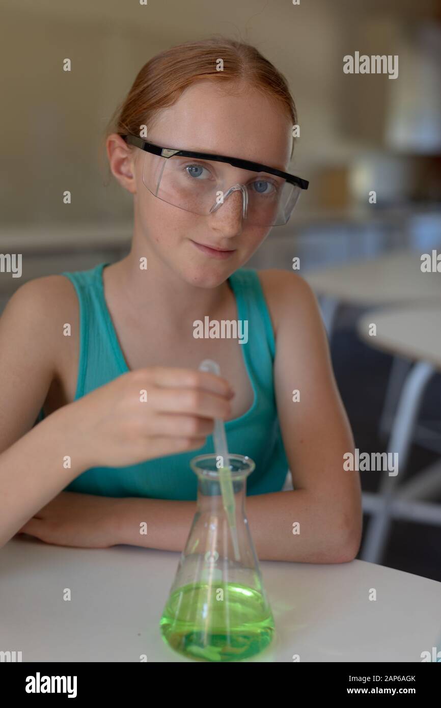 Elementary school girl in chemistry class Stock Photo - Alamy