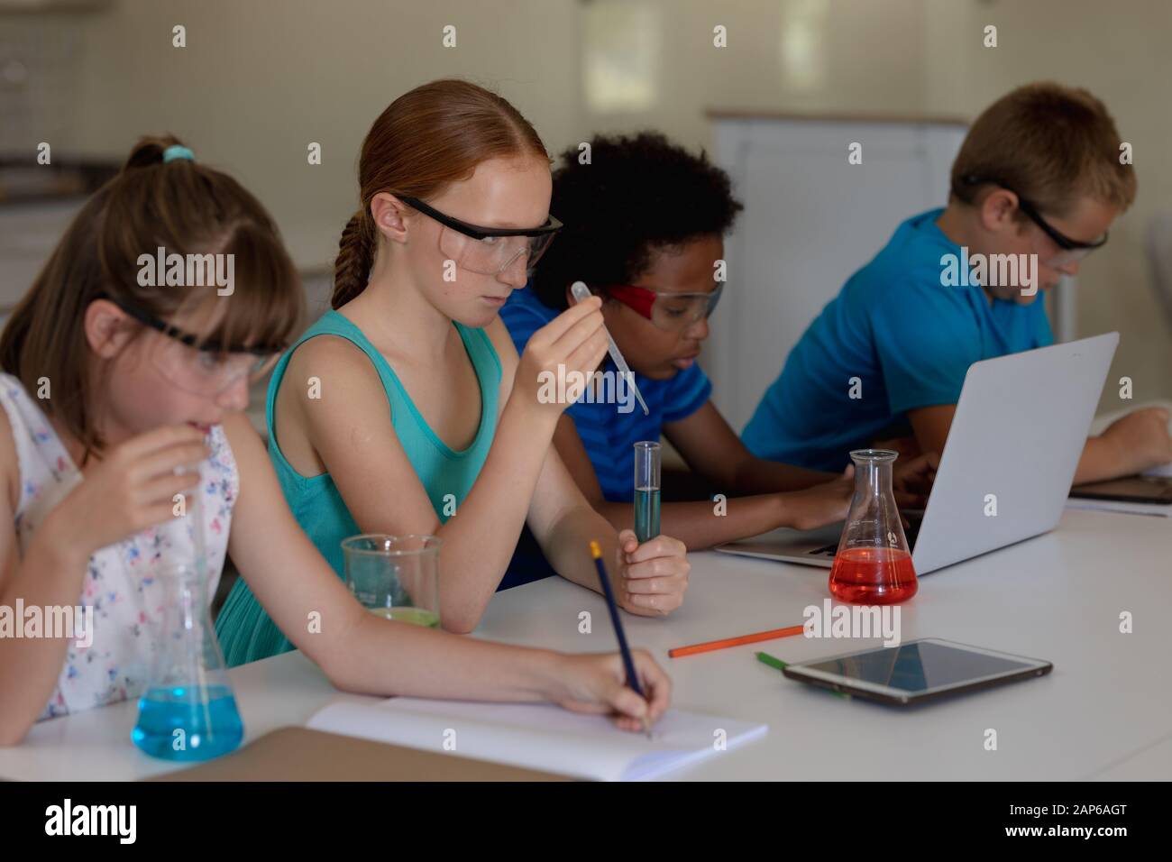 Group of elementary school kids in chemistry class Stock Photo - Alamy
