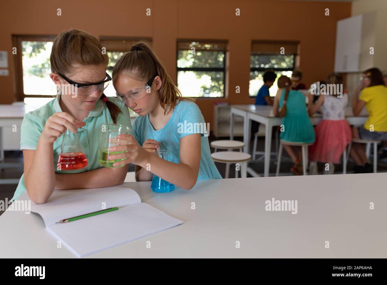 Two elementary school girls in chemistry class Stock Photo - Alamy