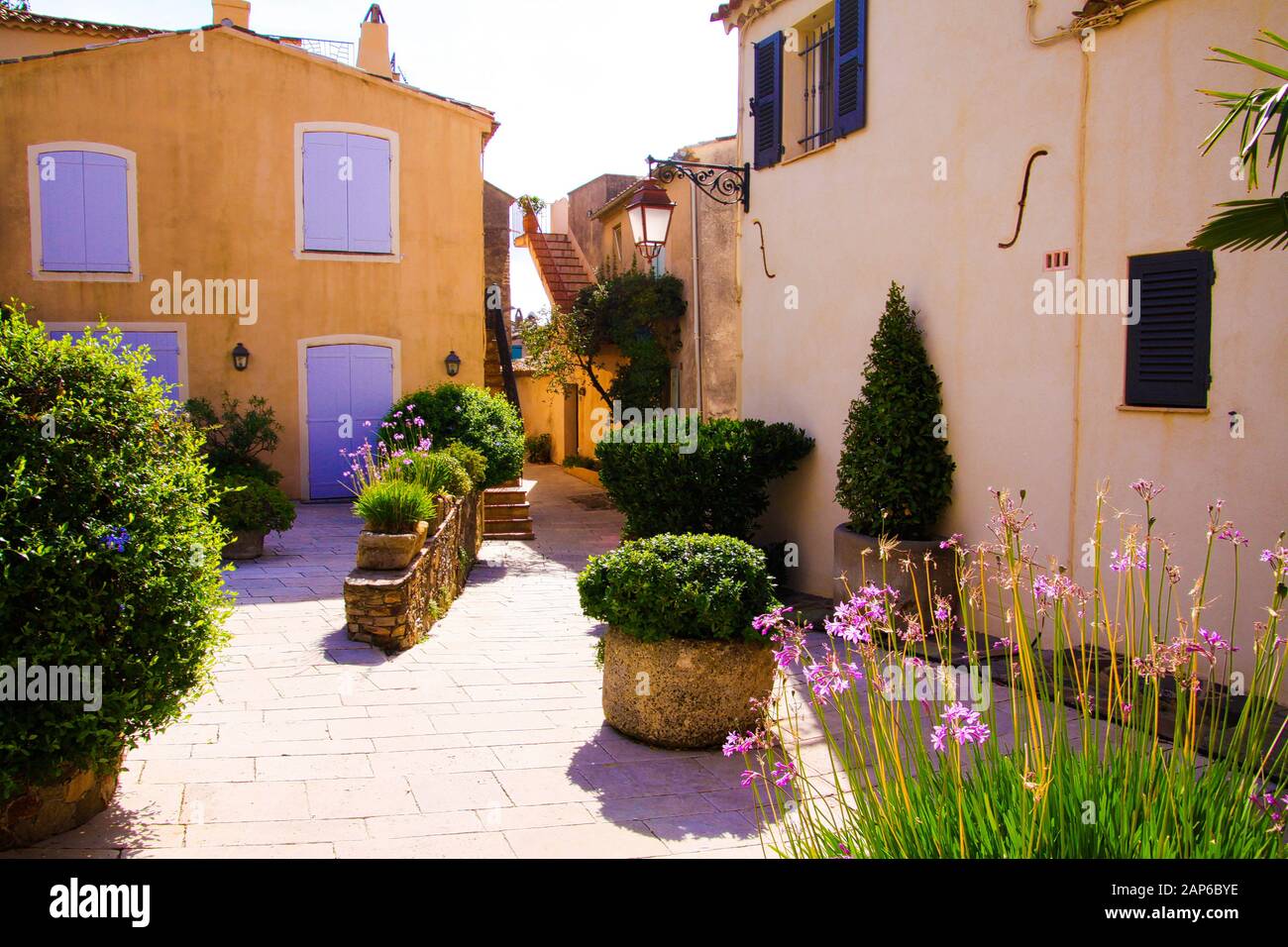 View on square of mediterranean village decorated with pots of flowers ...