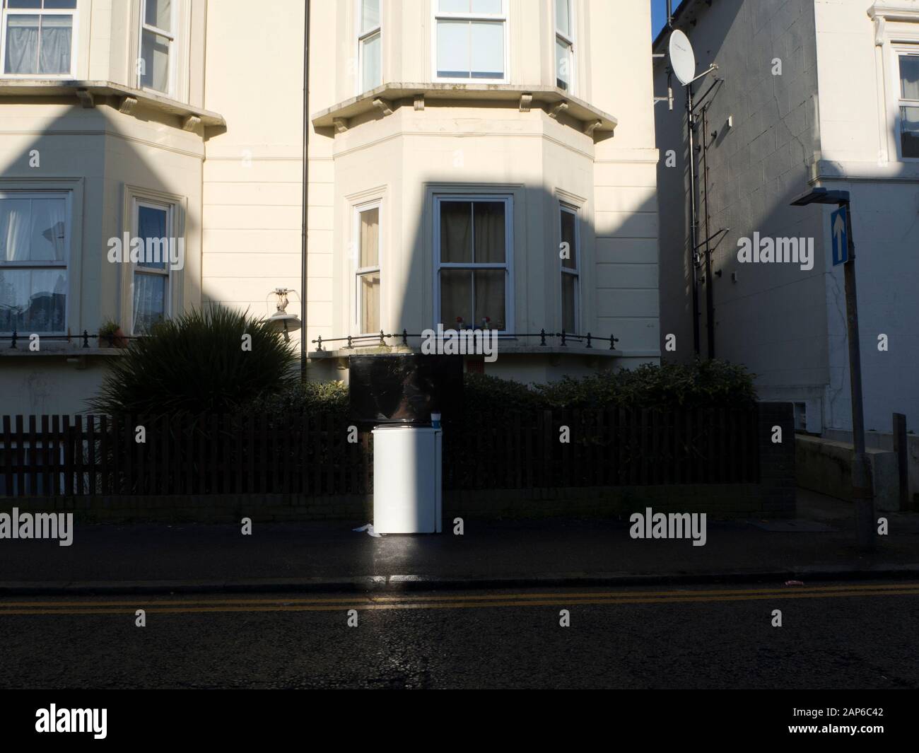 Fridge freezer fly tipped in a residential street Stock Photo - Alamy