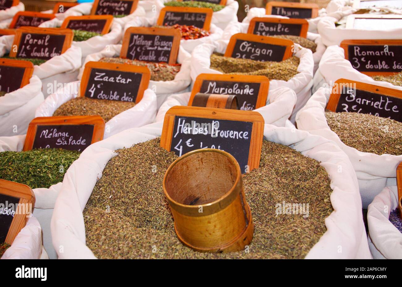 Choice of French spices (herbes de Provence) in white bags. Name of ...