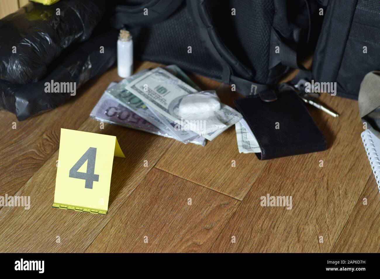 Big heroin packets and packs of money bills as evidence in crime scene ...