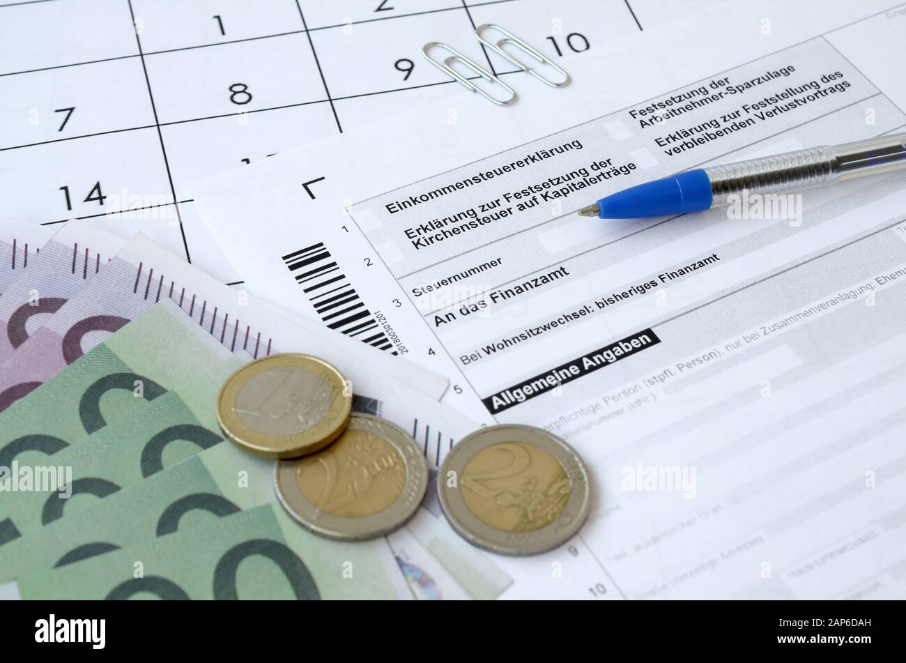 German tax form with pen and european money bills lies on office ...