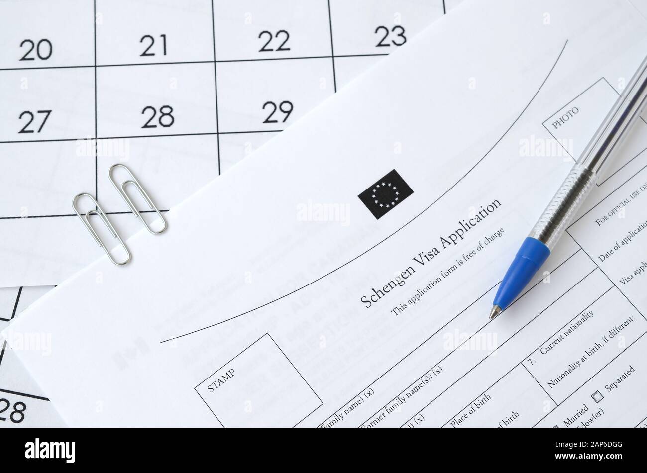 Schengen Visa application form and blue pen on paper calendar page ...