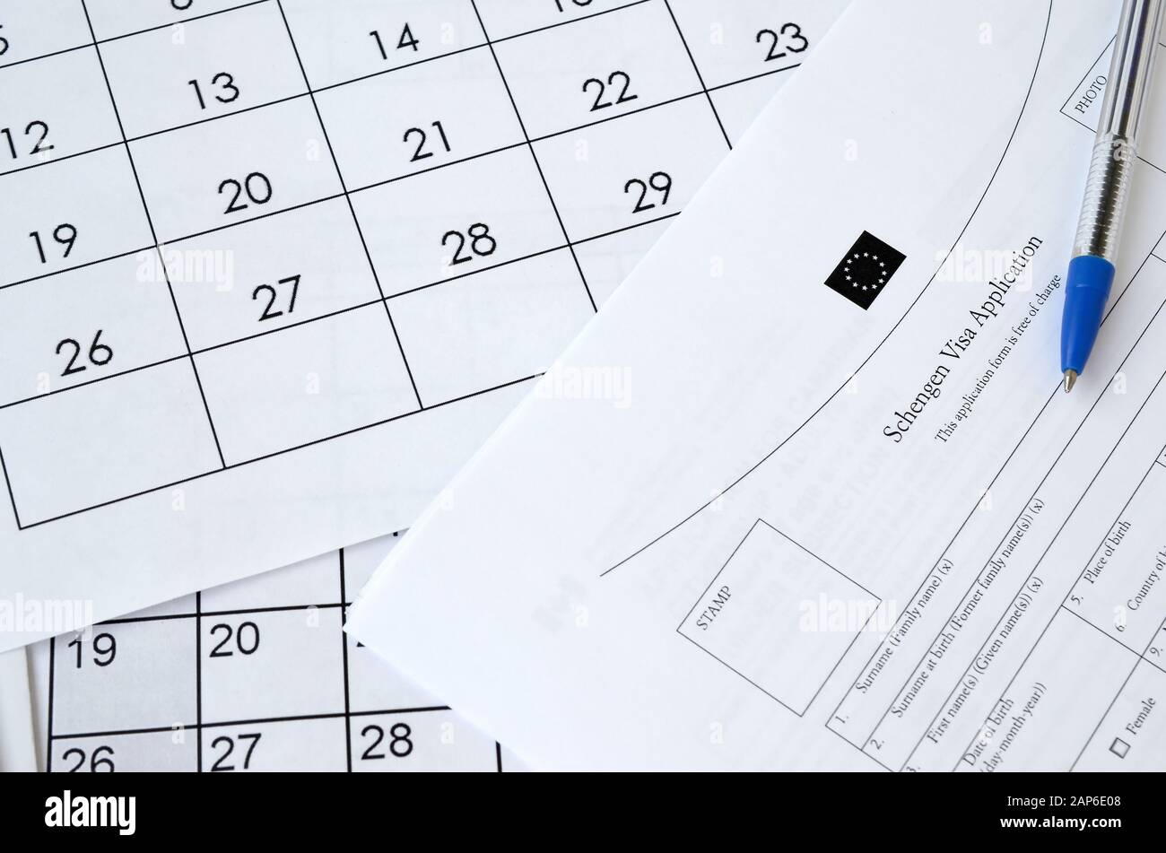 Schengen Visa application form and blue pen on paper calendar page ...