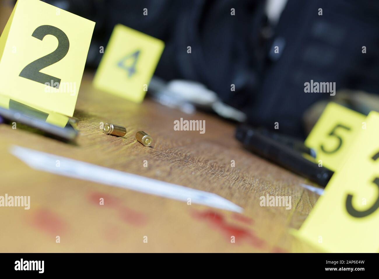 Id tents at crime scene after gunfight indoors. Gun cartridges as ...