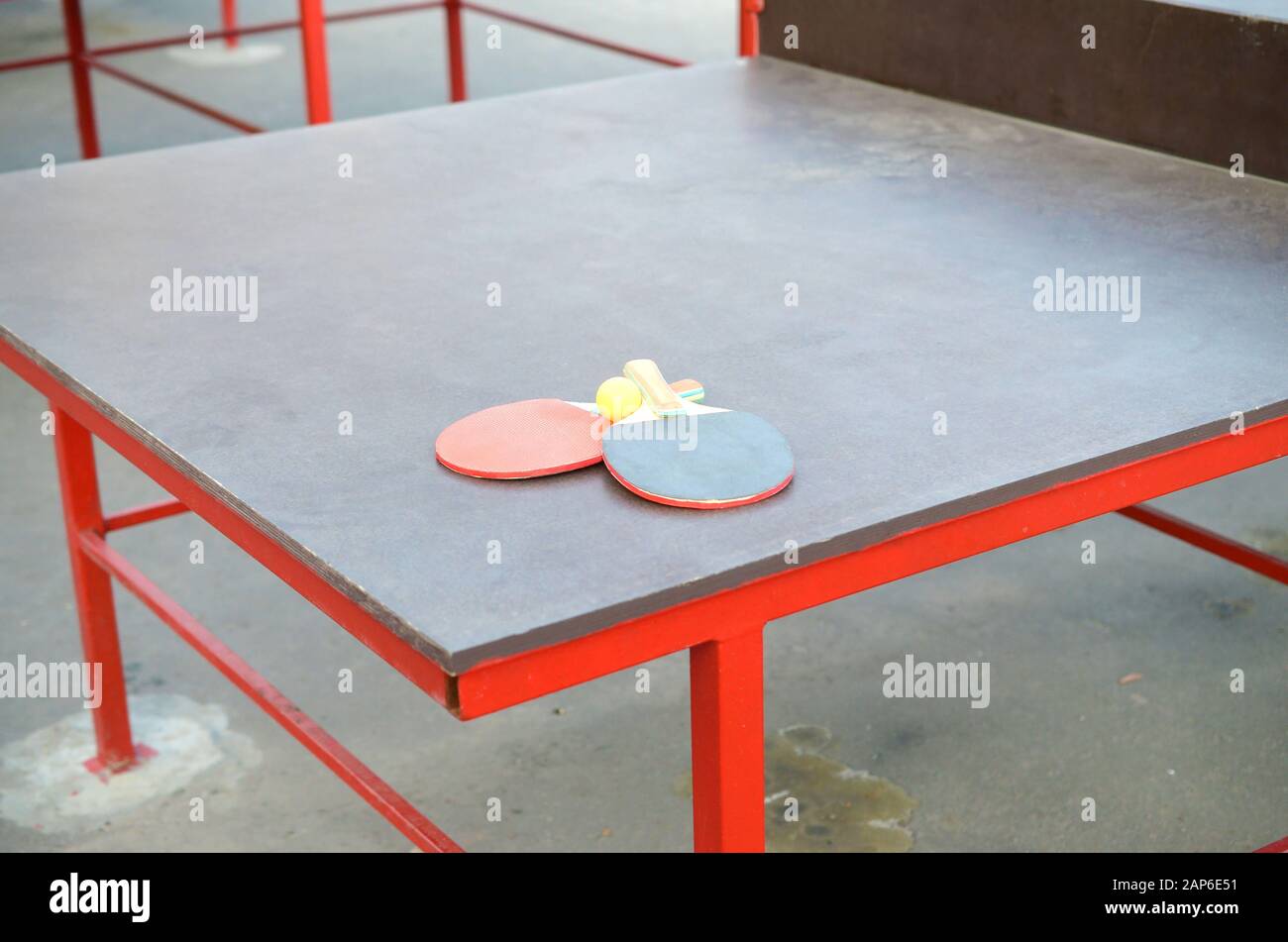 rackets and ball close up on Ping pong table in outdoor sport yard ...