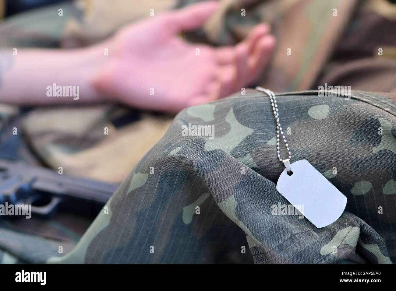 Empty army token of dead military soldier lies on camouflage clothes ...