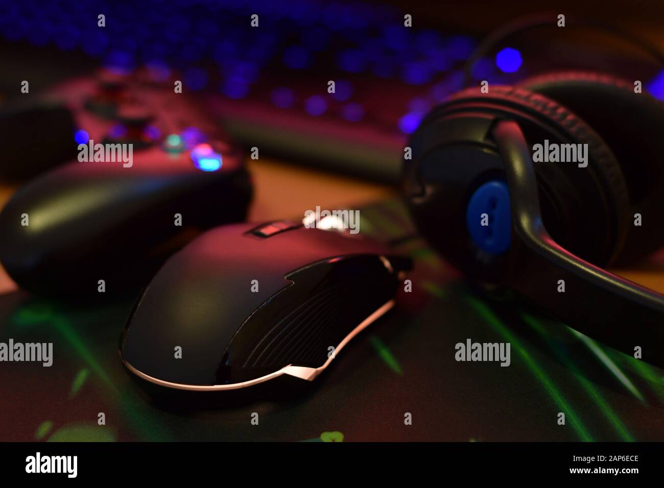 Modern gamepad and gaming mouse lies with keyboard and headphones on ...