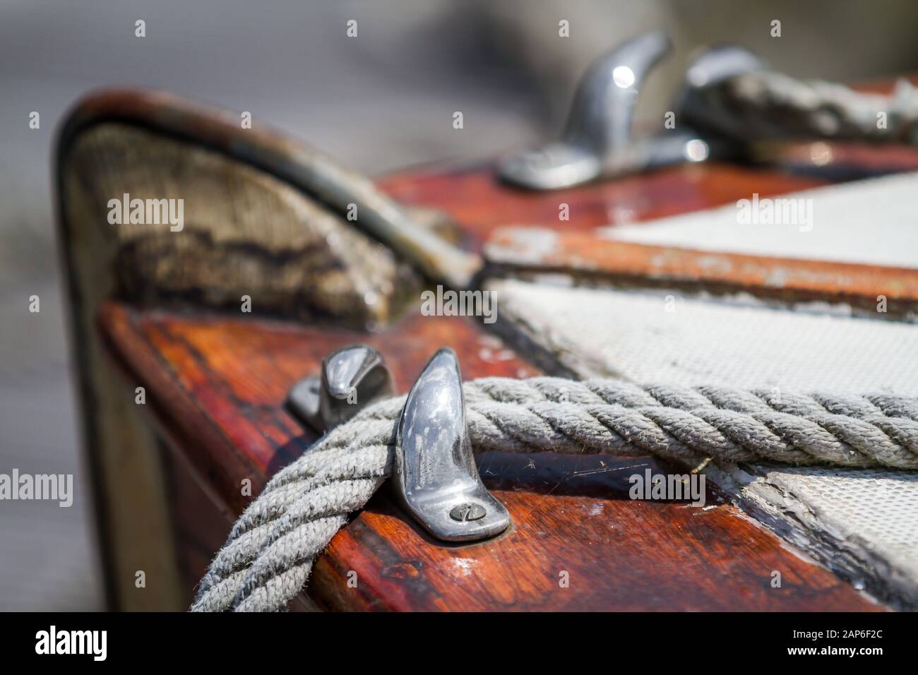 Metal Fairlead close-up on a vintage wooden Sailboat Stock Photo - Alamy