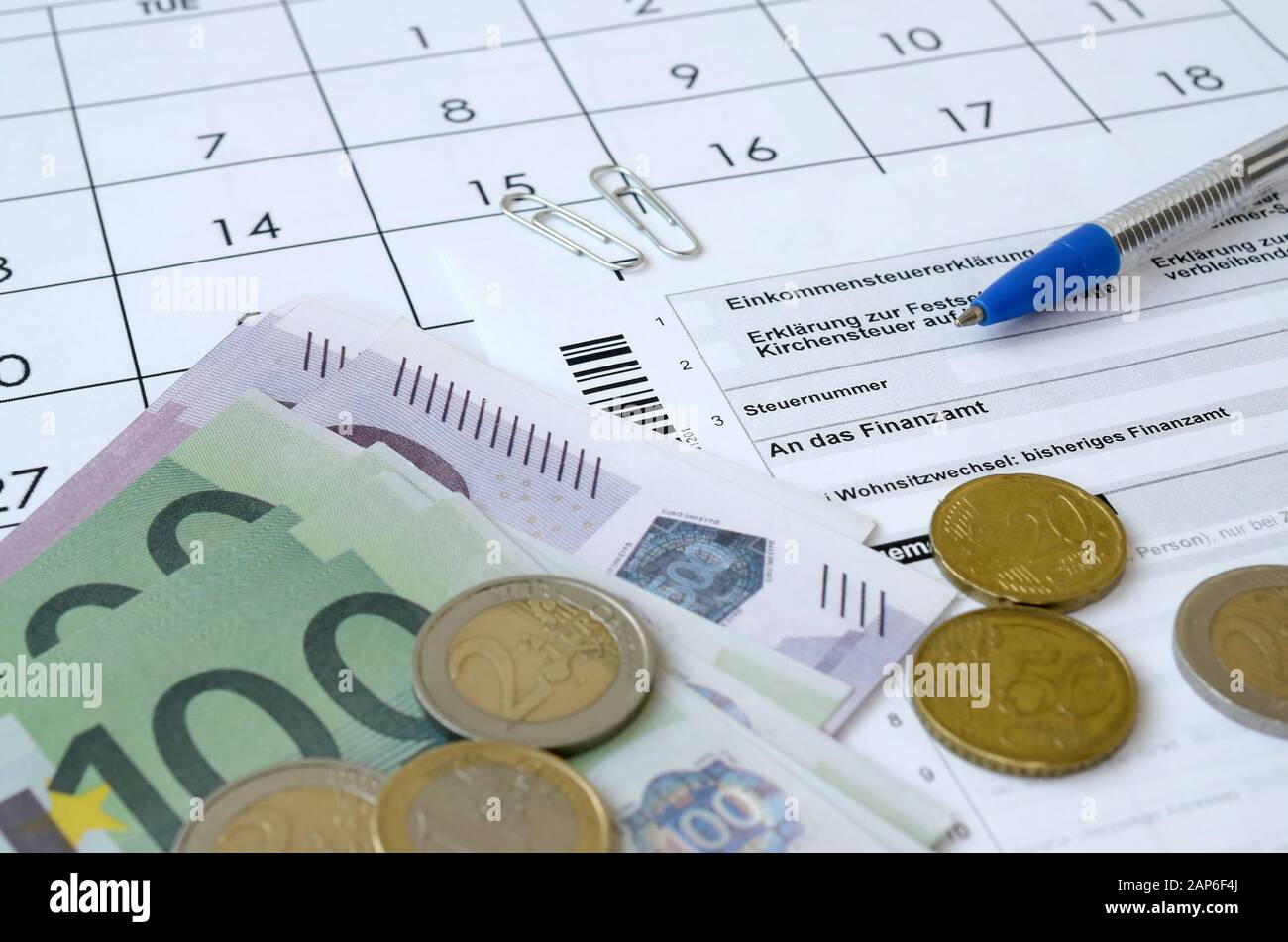 German tax form with pen and european money bills lies on office ...