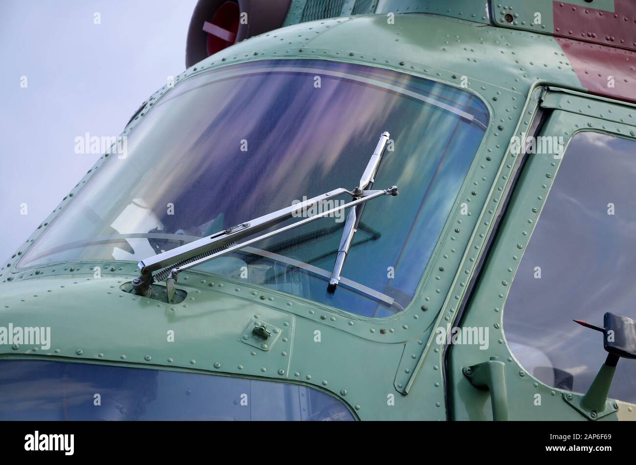 Close up view on helicopter cabin fragment. Camouflage aircraft ...