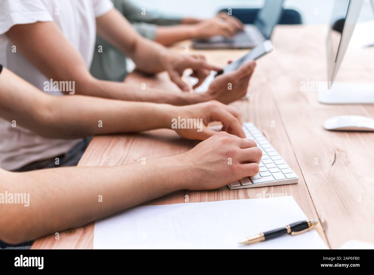 close up. a group of employees use devices in the office Stock Photo ...
