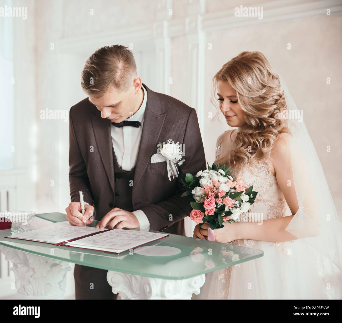 Bride groom signing marriage certificate hi-res stock photography and ...