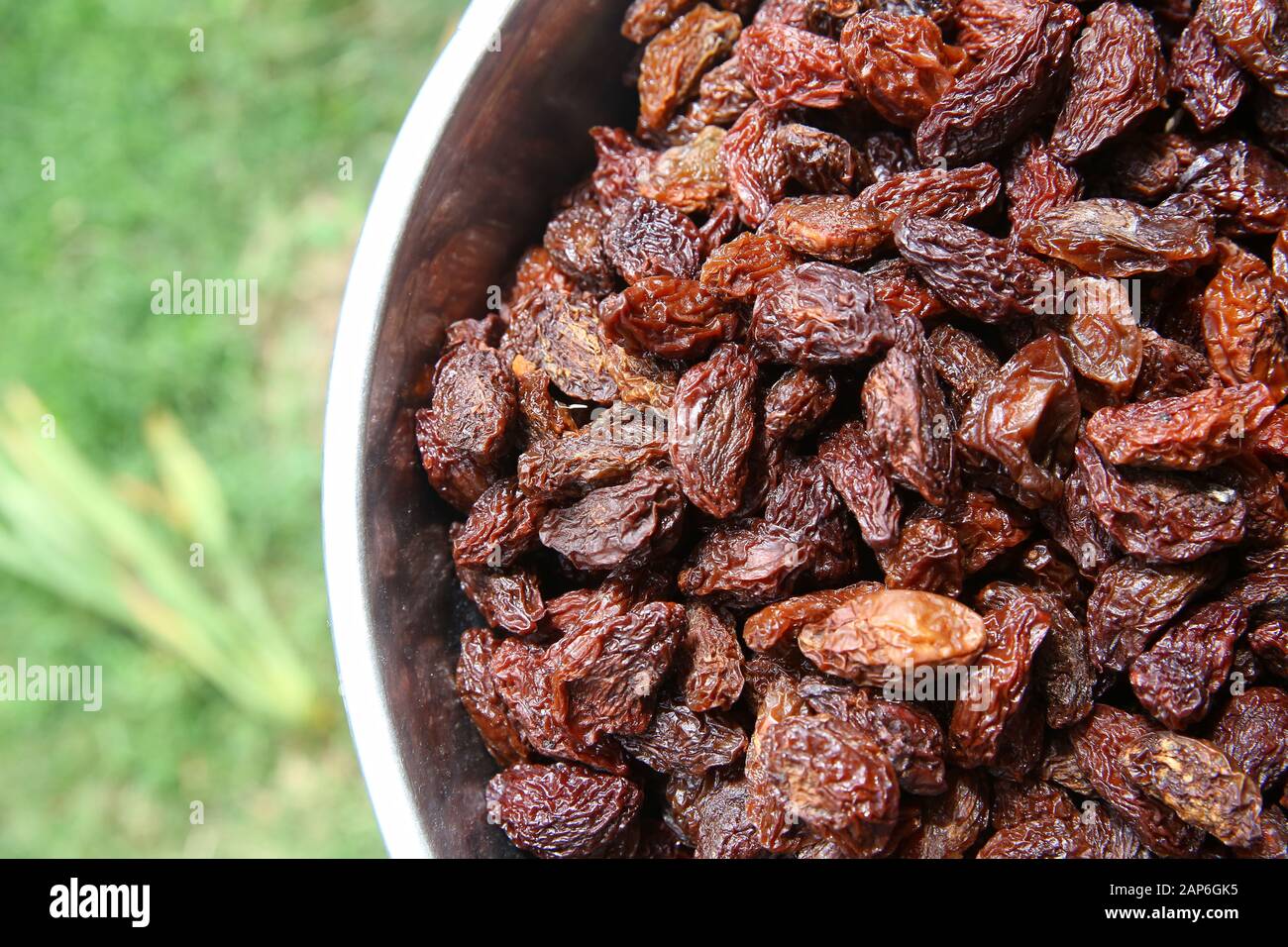 Sweet dry raisins close-up shot for green background . Many Raisins for ...