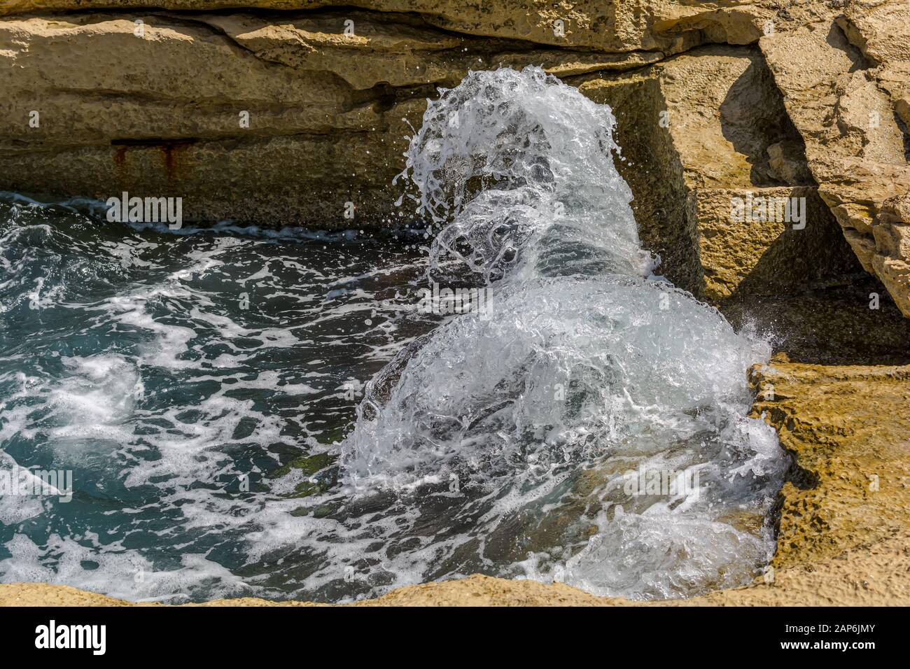 Wave breaks on rocks in Malta Stock Photo - Alamy