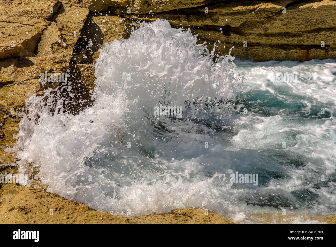 Wave breaks on rocks in Malta Stock Photo - Alamy