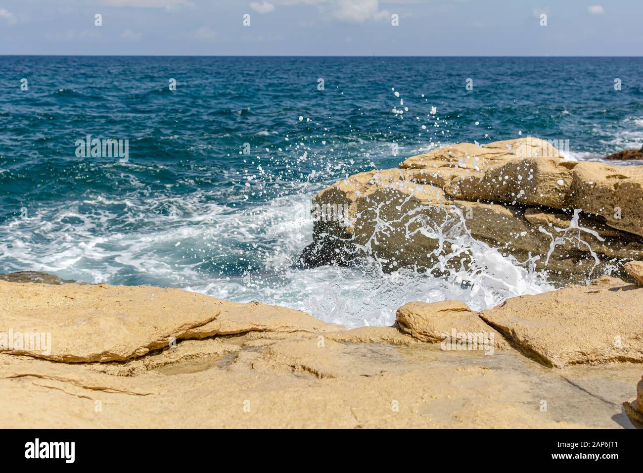 Wave breaks on rocks in Malta Stock Photo - Alamy