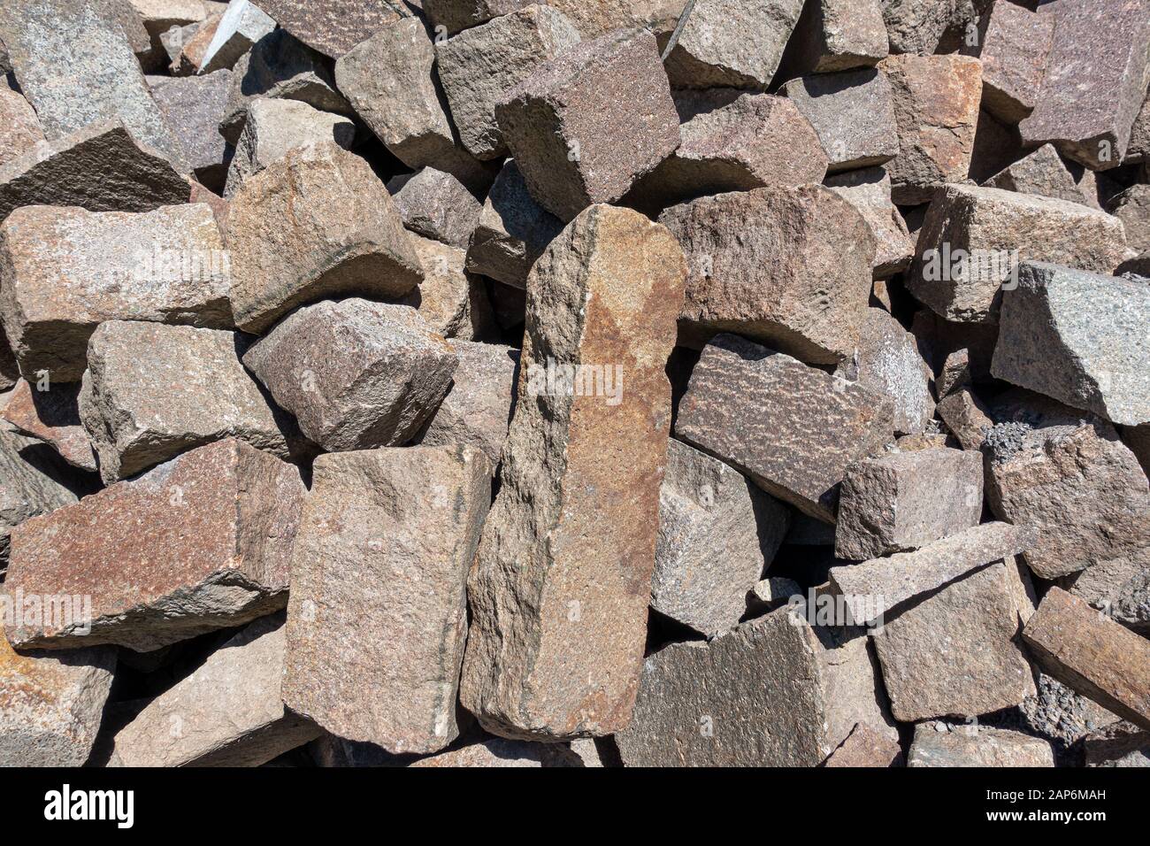 Rough, broken granite paving stones in a heap Stock Photo - Alamy