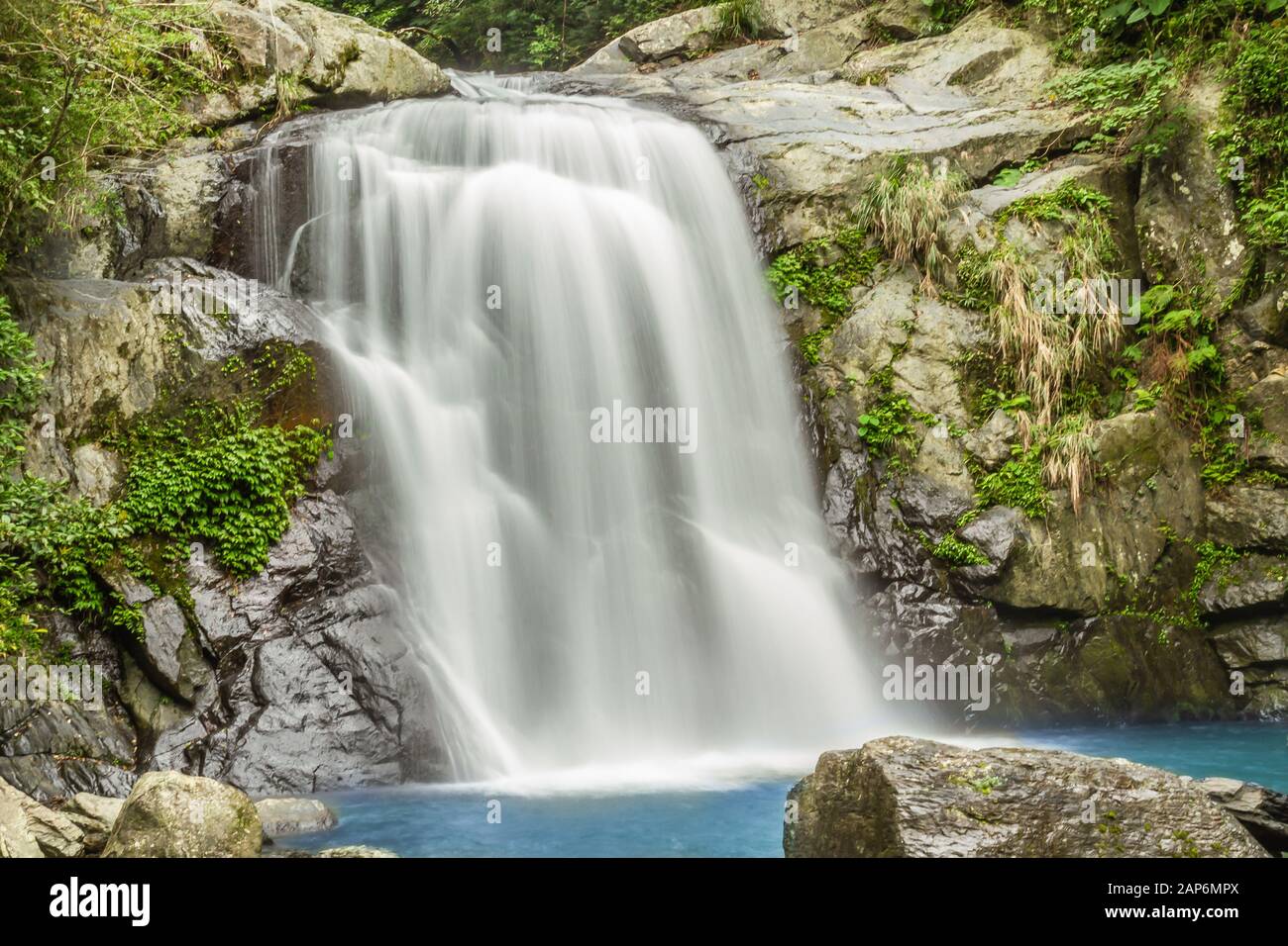 Waterfall with stream and rocks in rainforest Stock Photo - Alamy