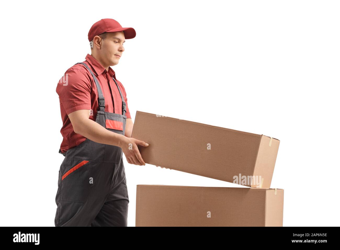 Male worker placing a box on top of a stack isolated on white ...