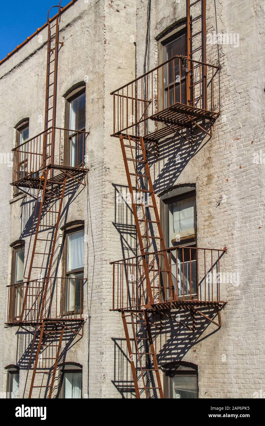 New York Building Fire Escape with white brick wall Stock Photo - Alamy
