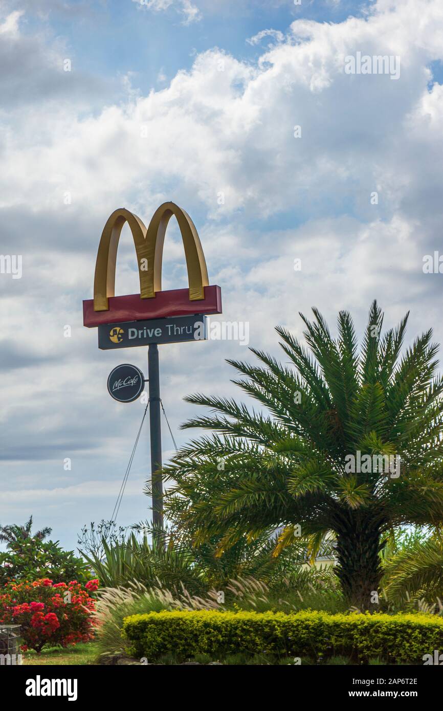 Mauritius, December 2015 - A MacDonald's sign surrounded by exotic ...