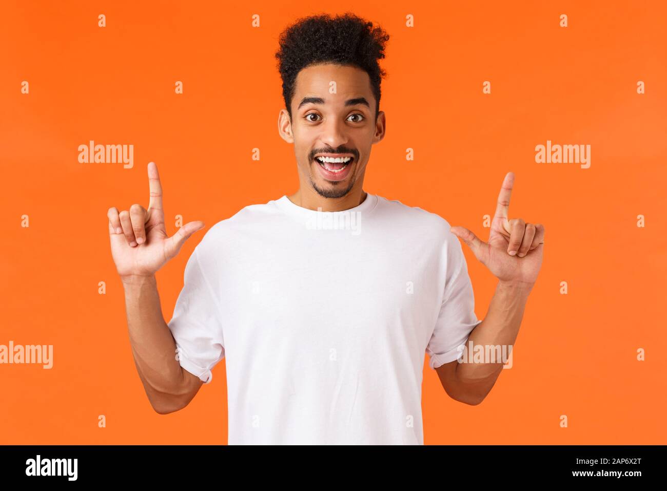 Excited and intrigued, enthusiastic african-american male in t-shirt ...