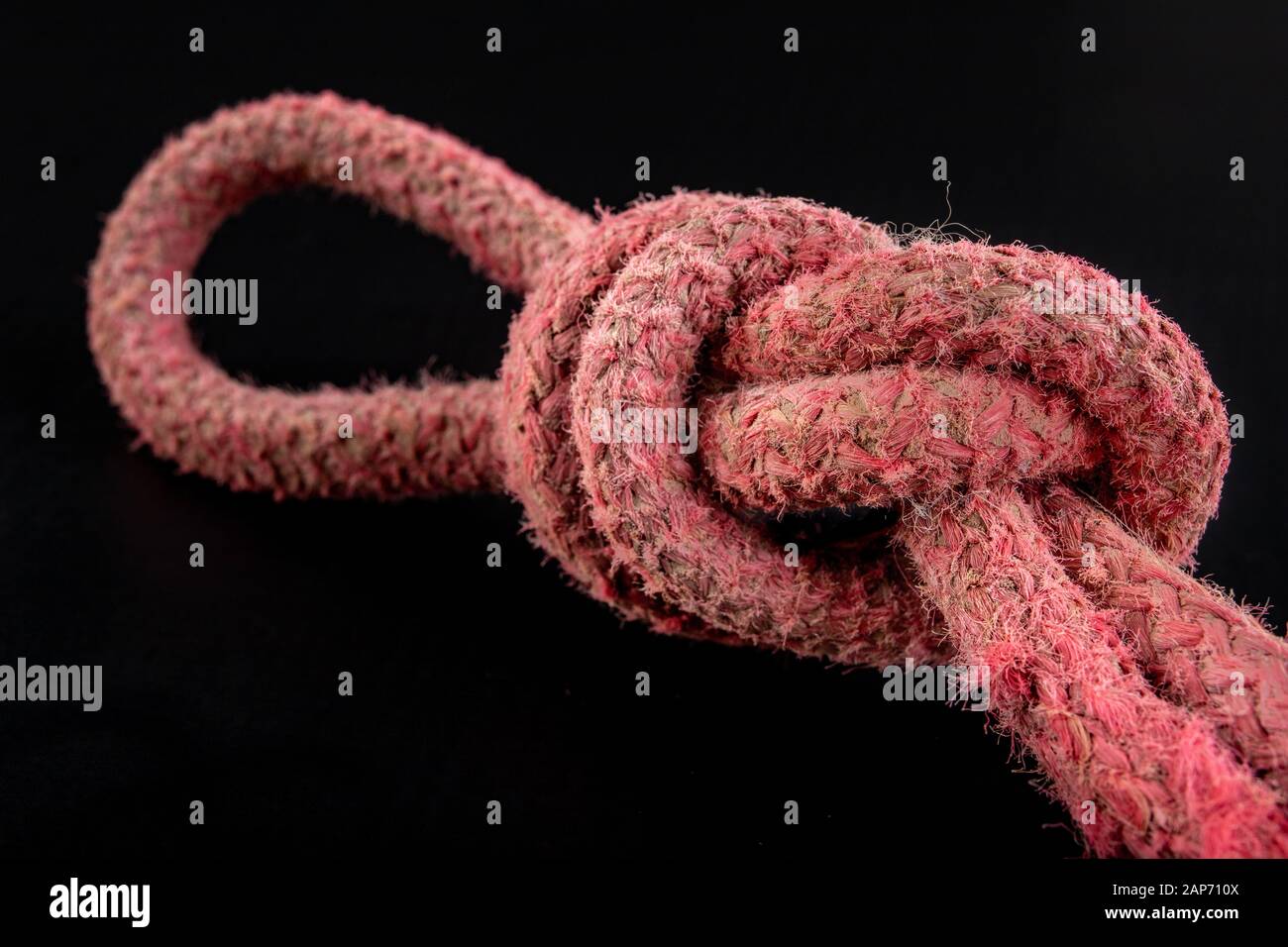 Loop made of thick rope. Loop-shaped knot. Dark background Stock Photo ...