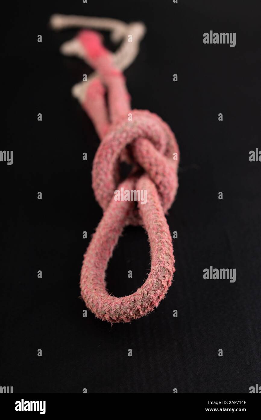 Loop made of thick rope. Loop-shaped knot. Dark background Stock Photo ...