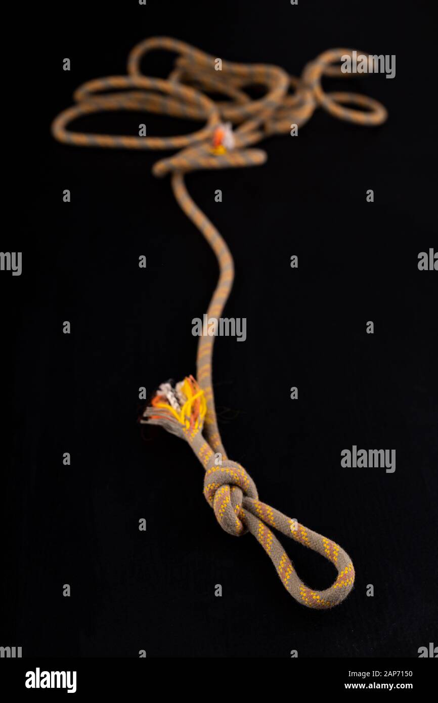 Loop made of thick rope. Loop-shaped knot. Dark background Stock Photo ...