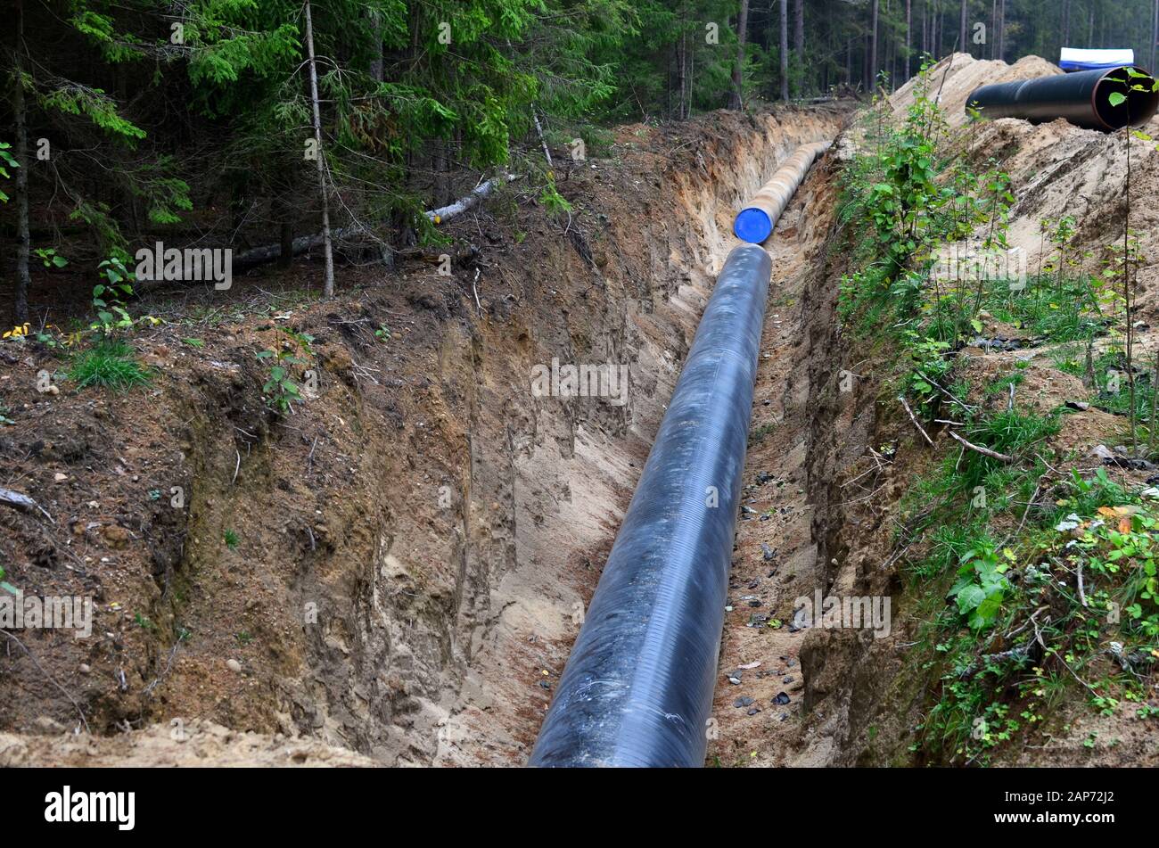 Natural gas pipeline construction work. A dug trench in the ground for ...