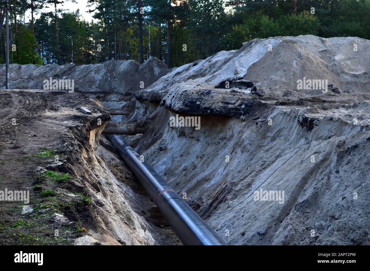 Natural gas pipeline construction work. A dug trench in the ground for ...
